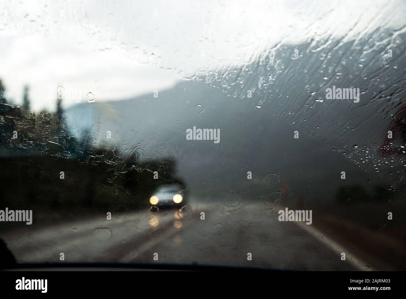 Car window with rain drops. Driving in rain. Weather background. Rainy ...