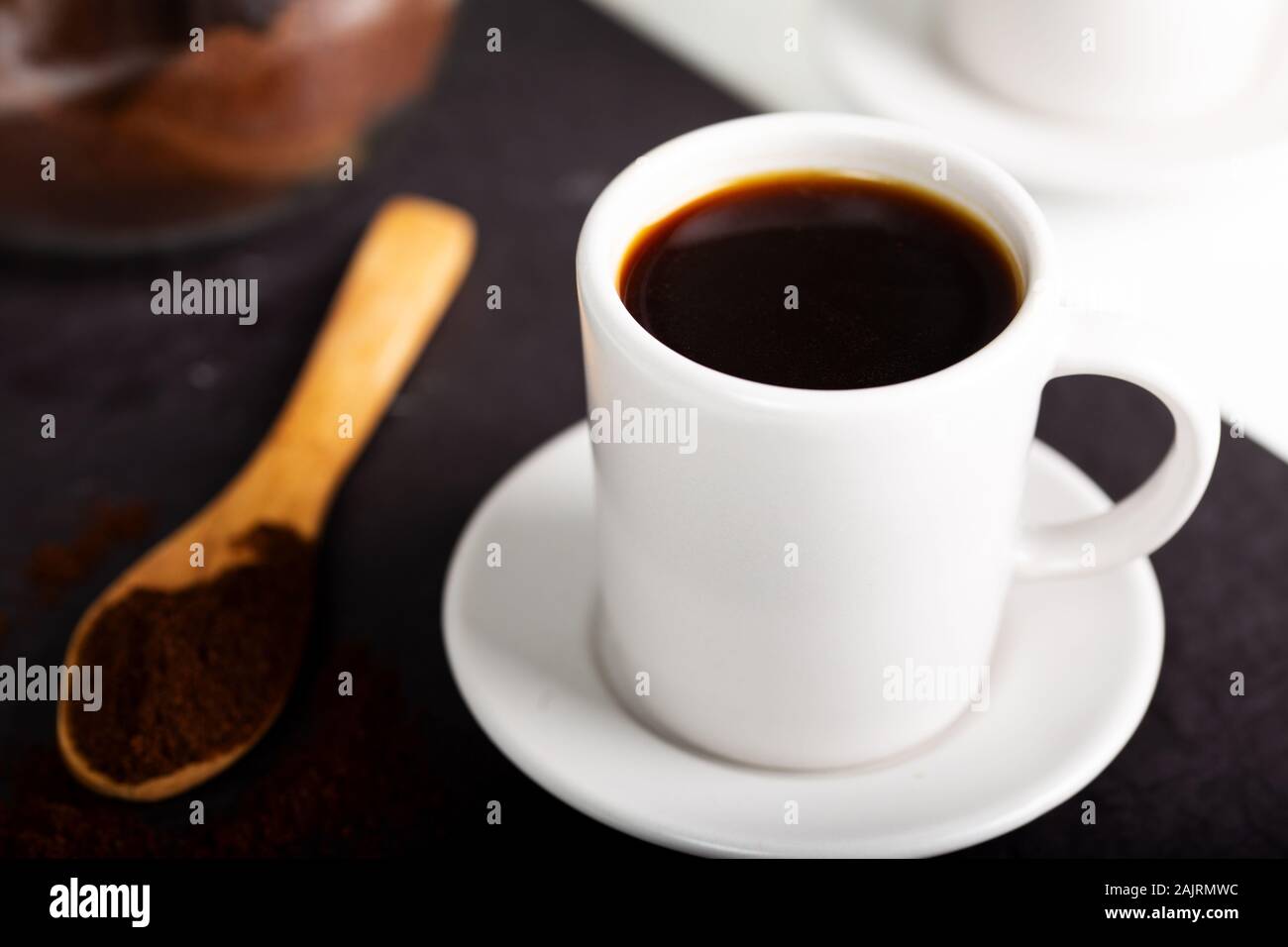 A coffee cup and a spoon spilling coffee powder Stock Photo - Alamy