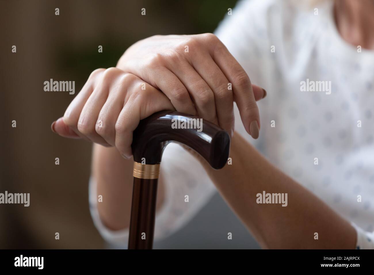 Close up of disabled senior woman hold walking cane Stock Photo - Alamy