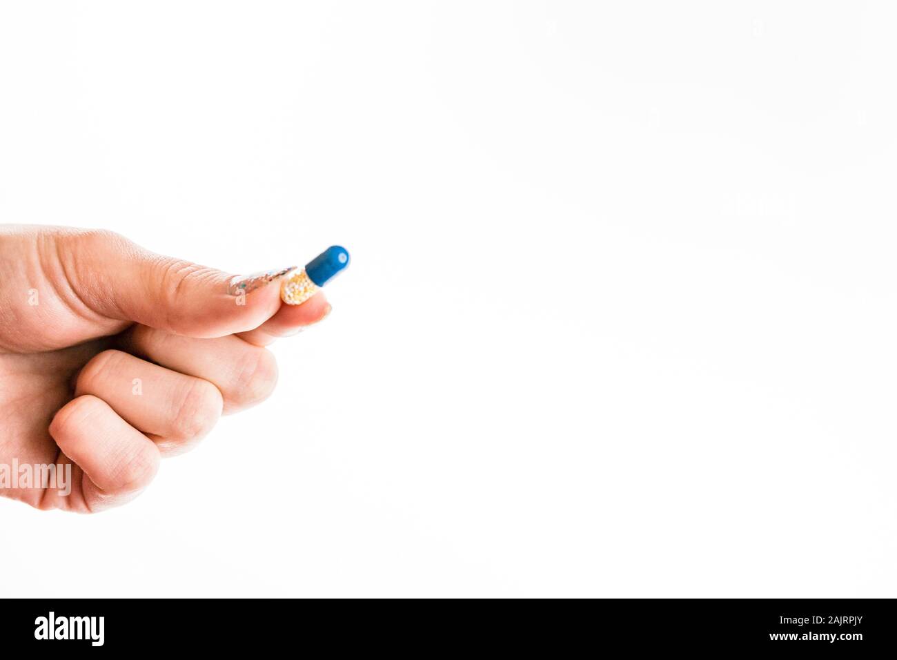 Hand holding antibiotics capsules or painkillers isolated on white ...