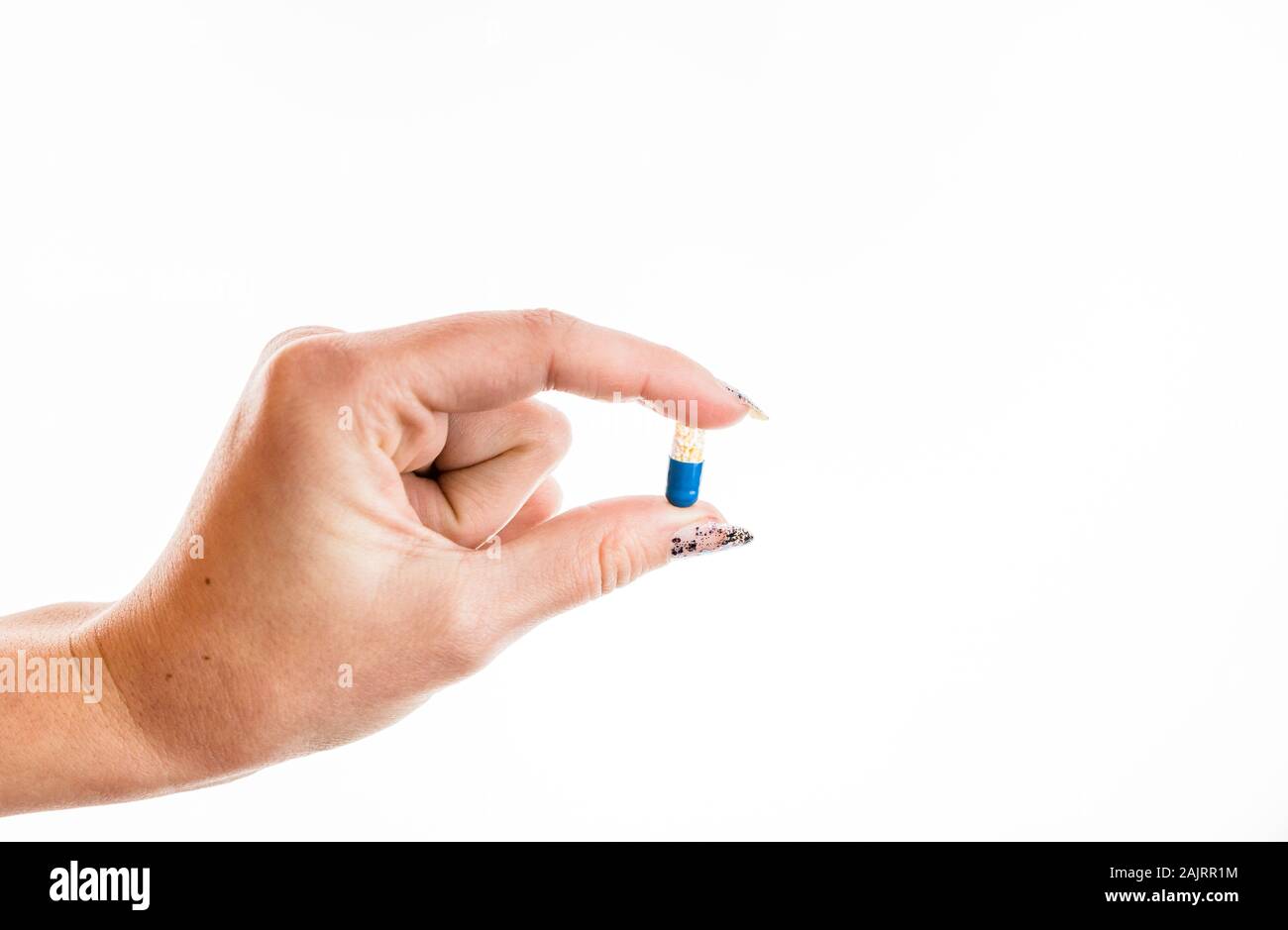 Hand holding antibiotics capsules or painkillers isolated on white ...