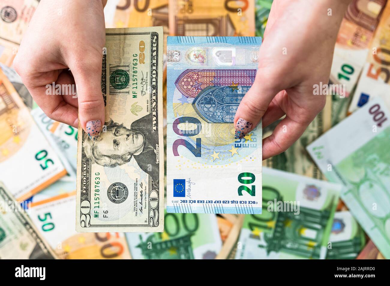 Hand holding money isolated on banknotes background. EURO and USD ...