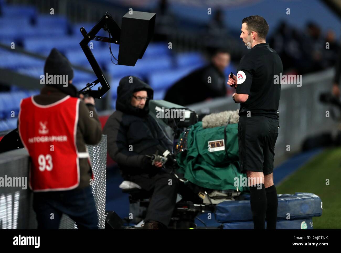 Referee Michael Oliver checks the VAR during the FA Cup third round ...