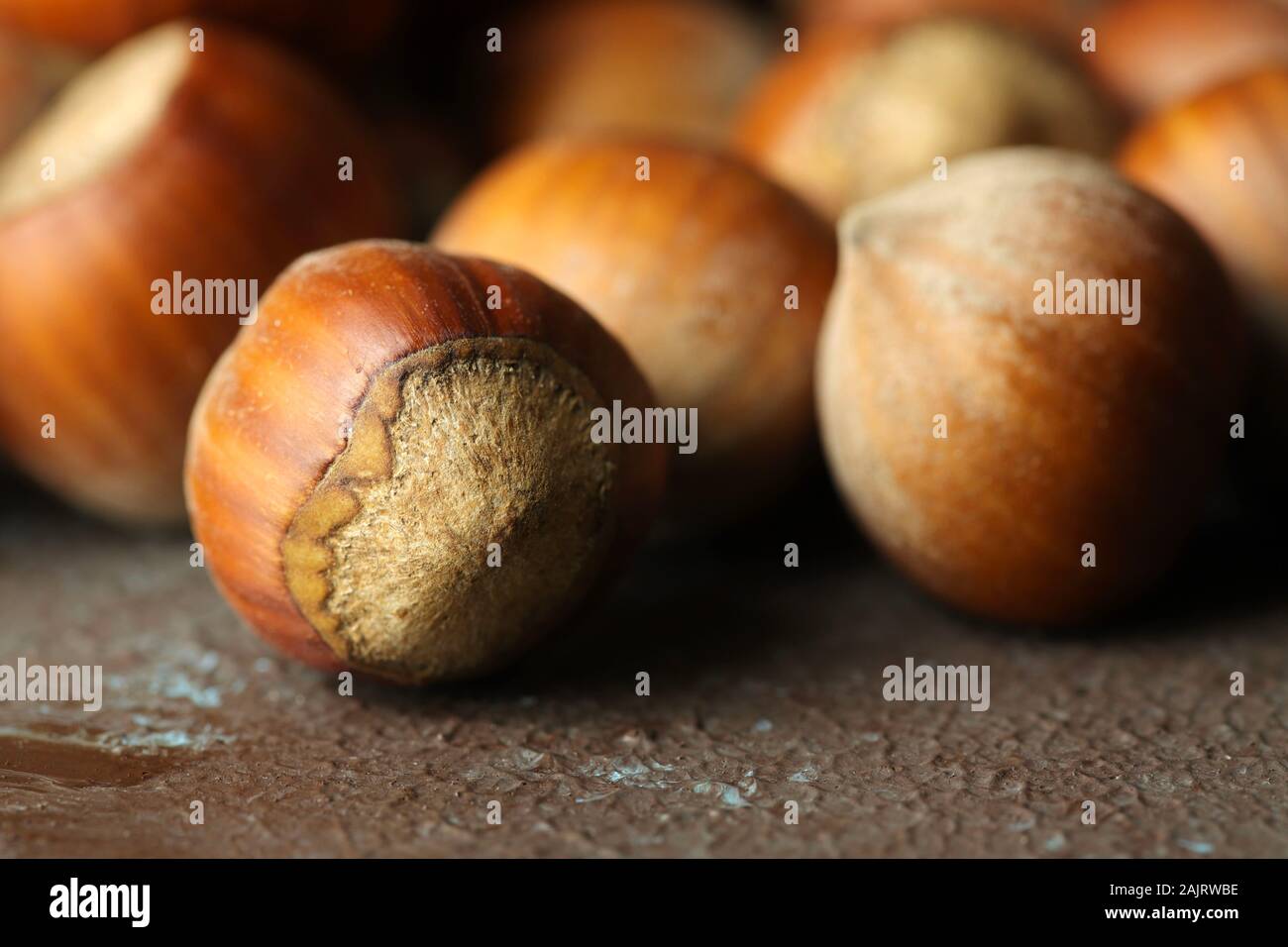 Closeup of group of Hazelnuts on wooden table. Hazelnut composition and ...