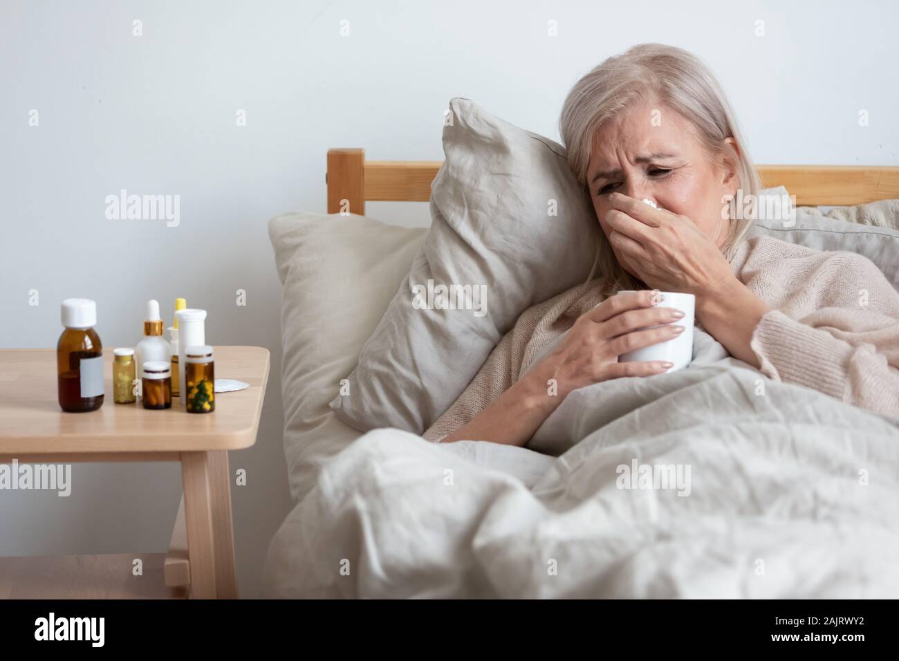 Sick old woman suffer from illness at home alone Stock Photo - Alamy