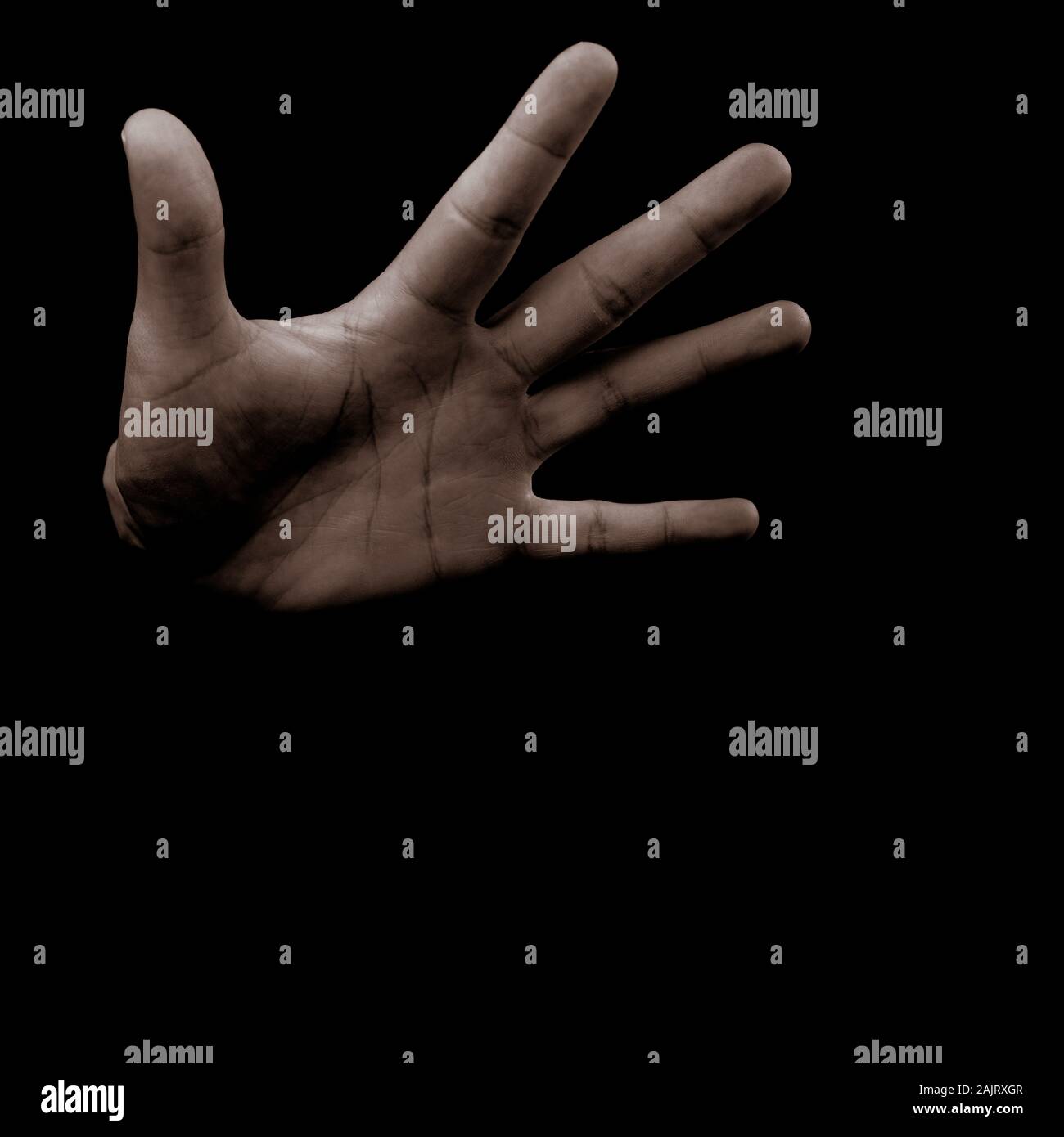 Open male hand on dark background Stock Photo - Alamy