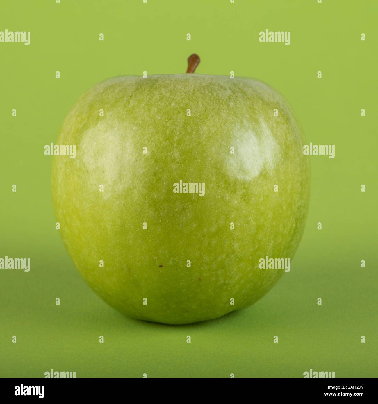 green apple with green background Stock Photo - Alamy