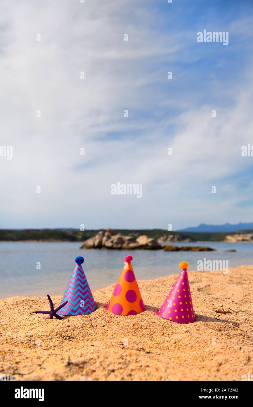 Colorful party hats at the beach Stock Photo - Alamy