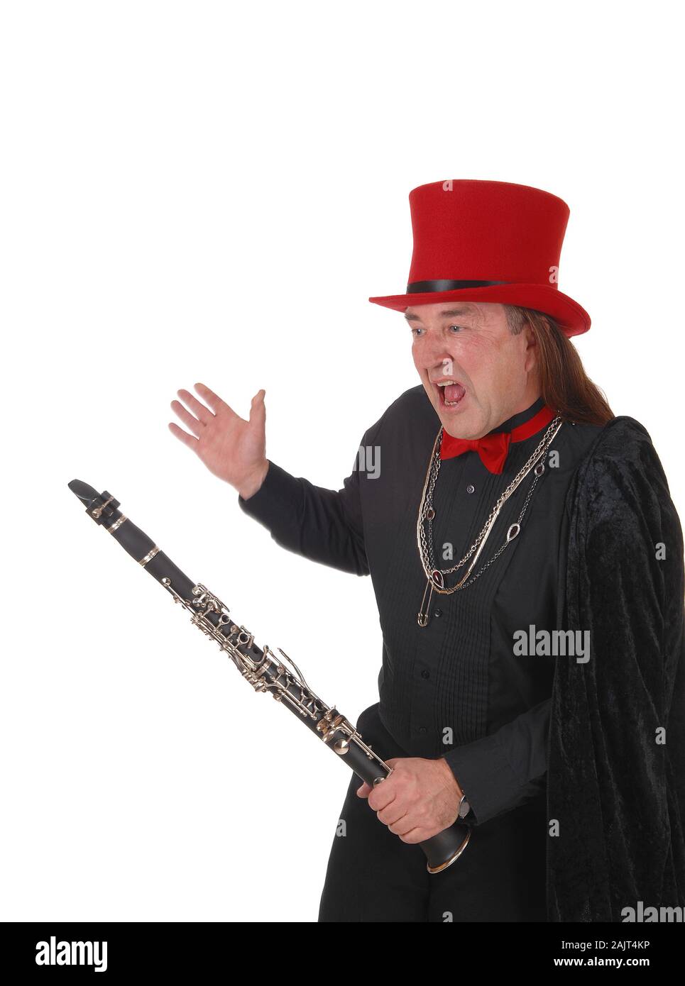 A middle age indigenous man holding his clarinet in a black outfit and ...