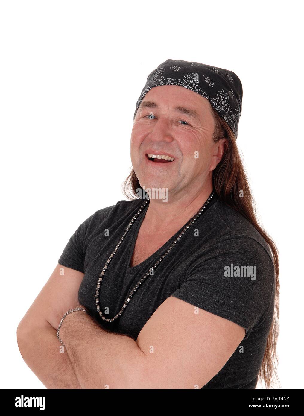 A happy indigenous man standing for a portrait image laughing, his long ...