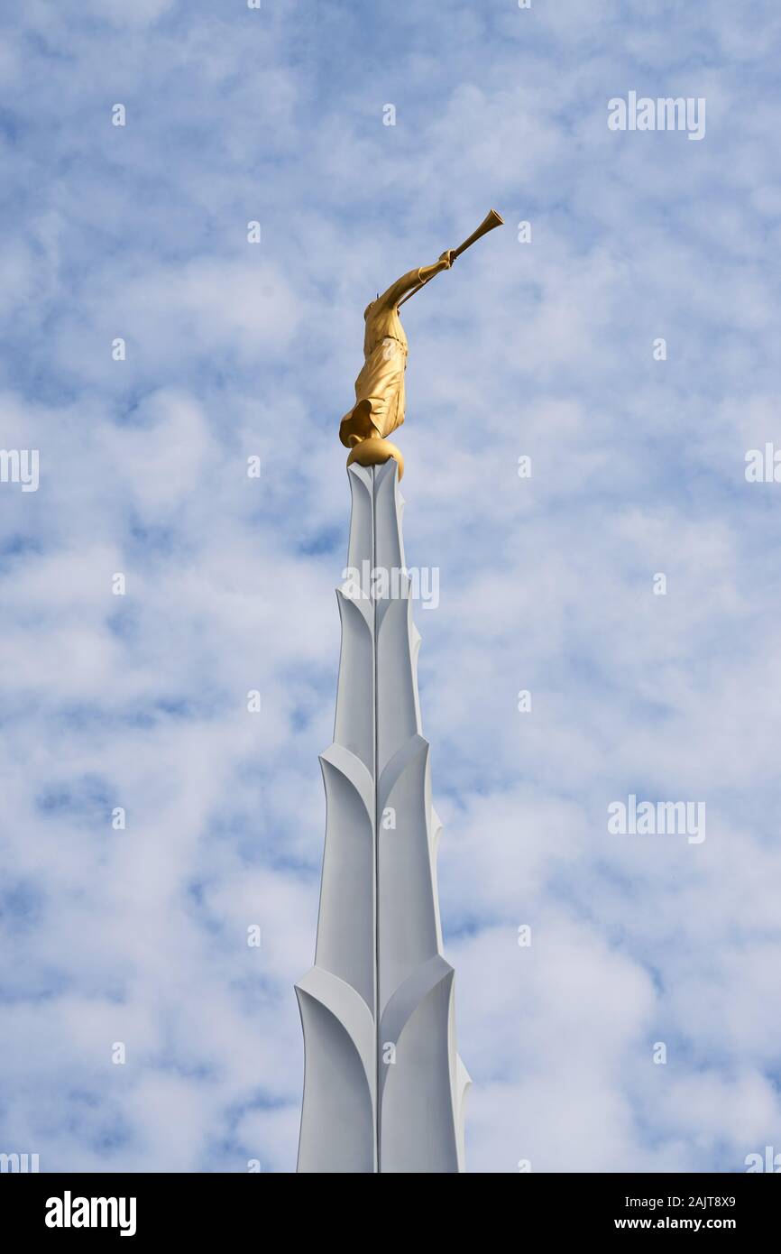 The golden Angel Moroni statue stands on top of a white spire located ...