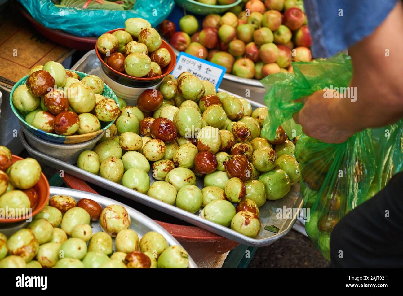 A customer bags fresh green jujube (Daechu 대추) a Korean fruit, for sale ...