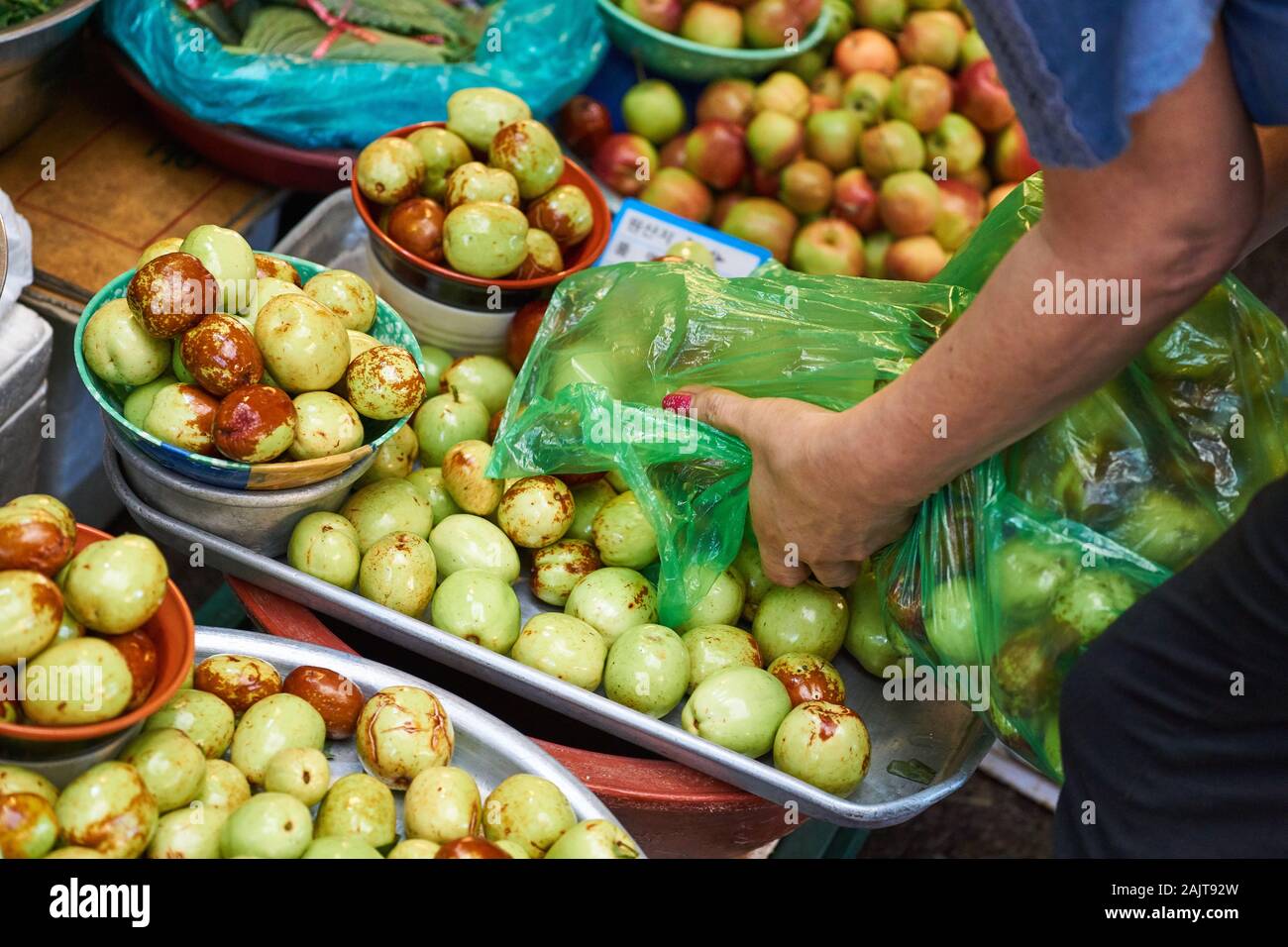 A customer bags fresh green jujube (Daechu 대추) a Korean fruit, for sale ...
