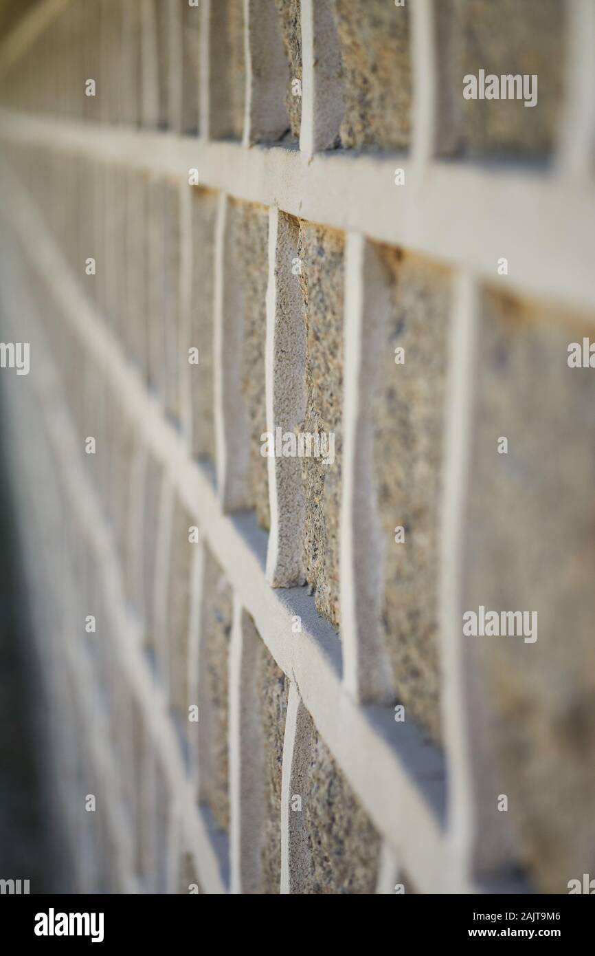 Gray stones in a simple repeating pattern on an outside wall in ...