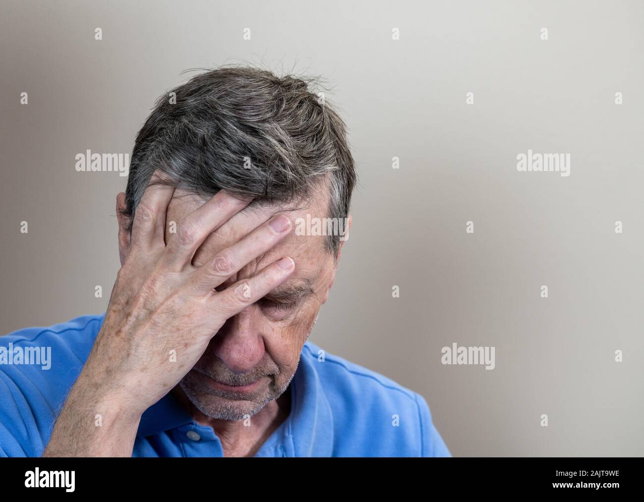 Head and shoulders portrait of a senior caucasian man with head in ...