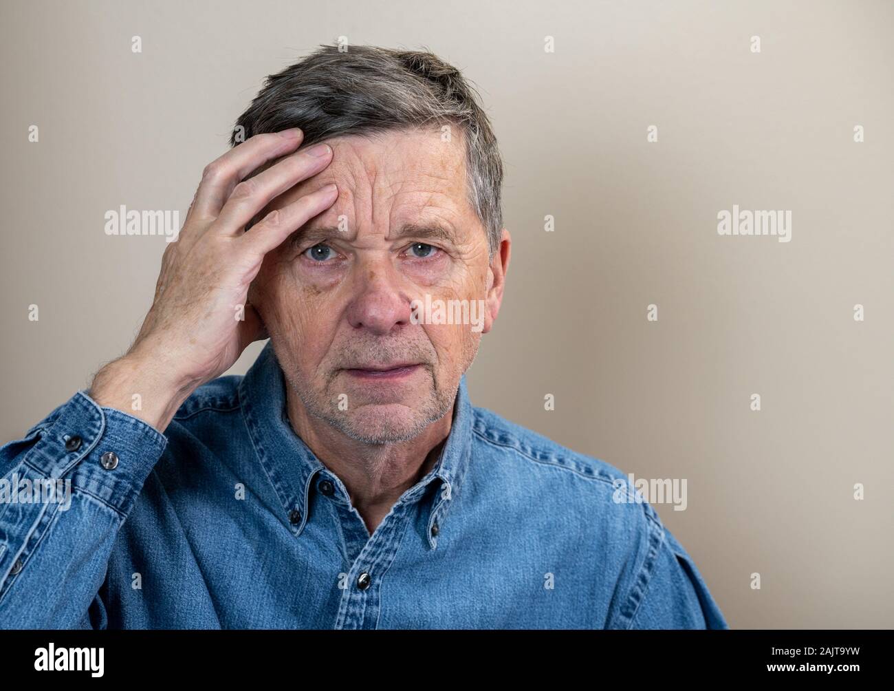 Head and shoulders portrait of a senior caucasian man with head in ...