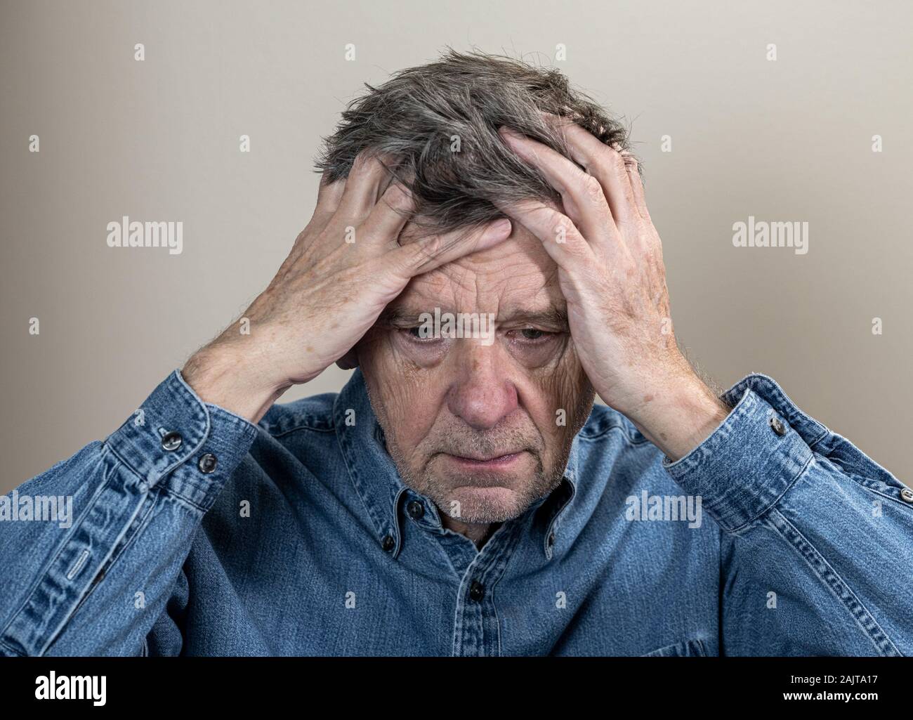 Head and shoulders portrait of a senior caucasian man with head in ...