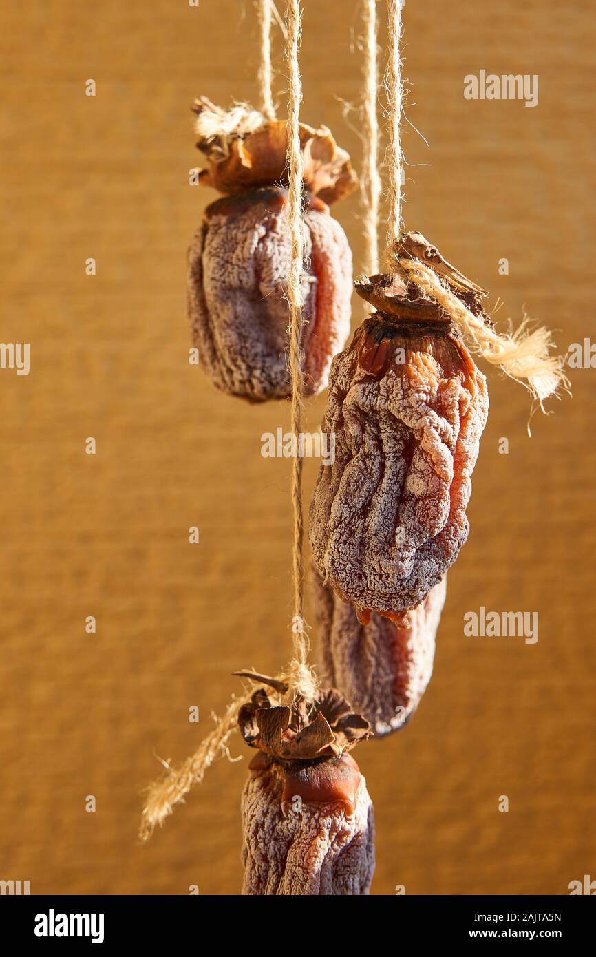 Fully dried persimmons (hoshigaki) with natural sugar coating hang from ...