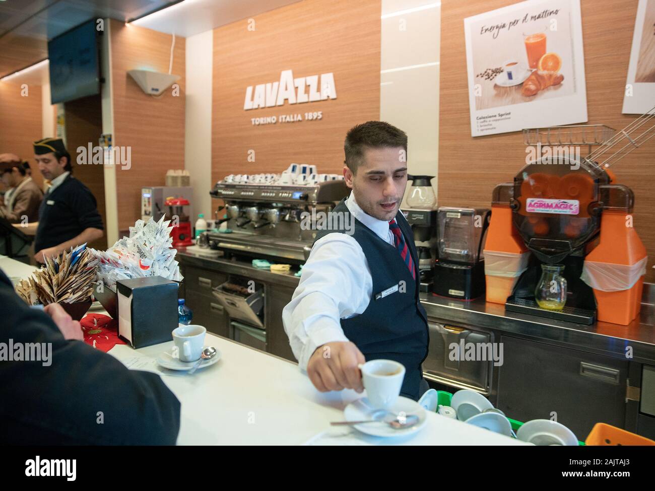 Bartender serves coffee in a cafe at the station . espresso in italian ...