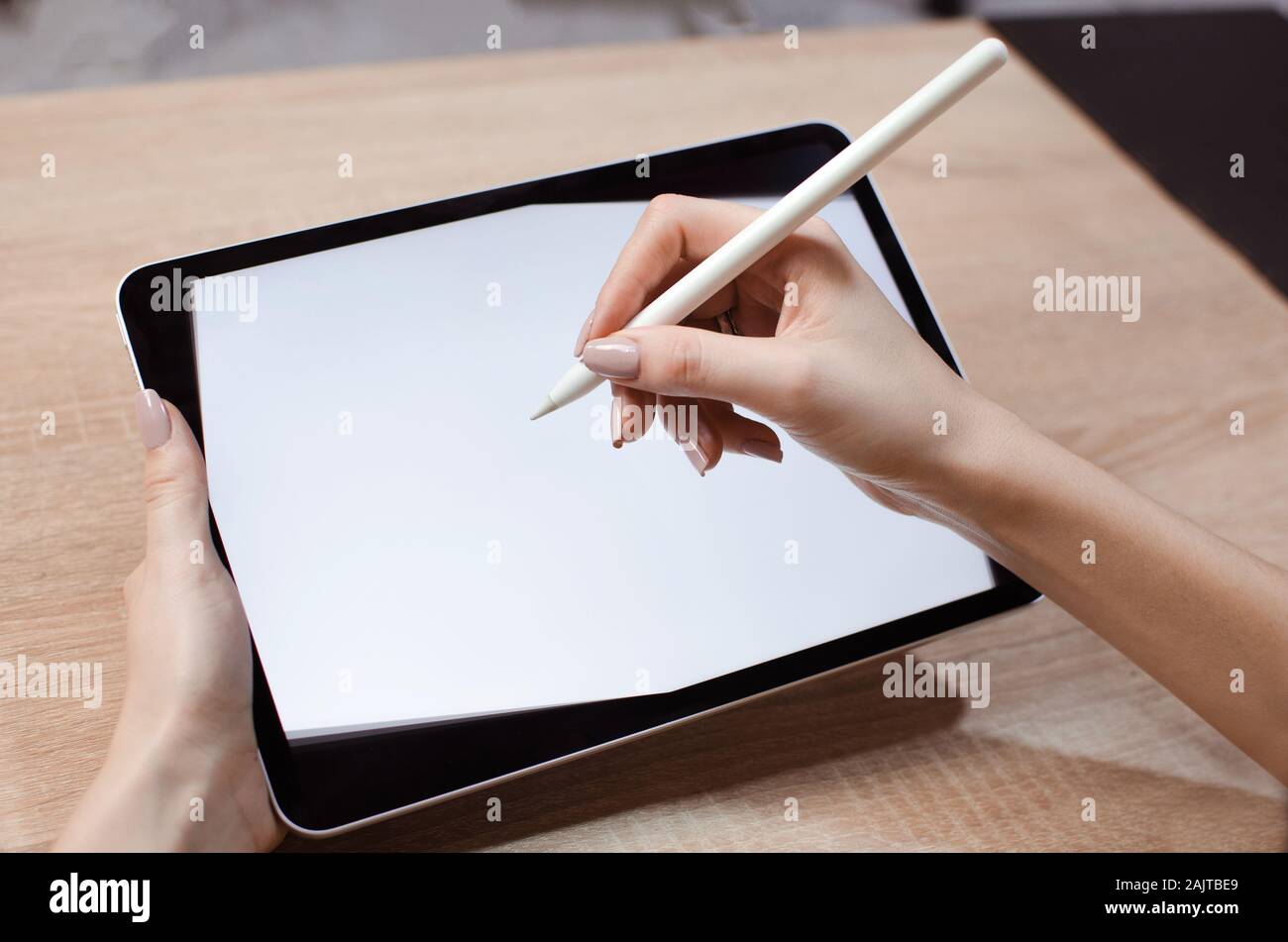 Girl using stylus on tablet to draw her ideas Stock Photo - Alamy