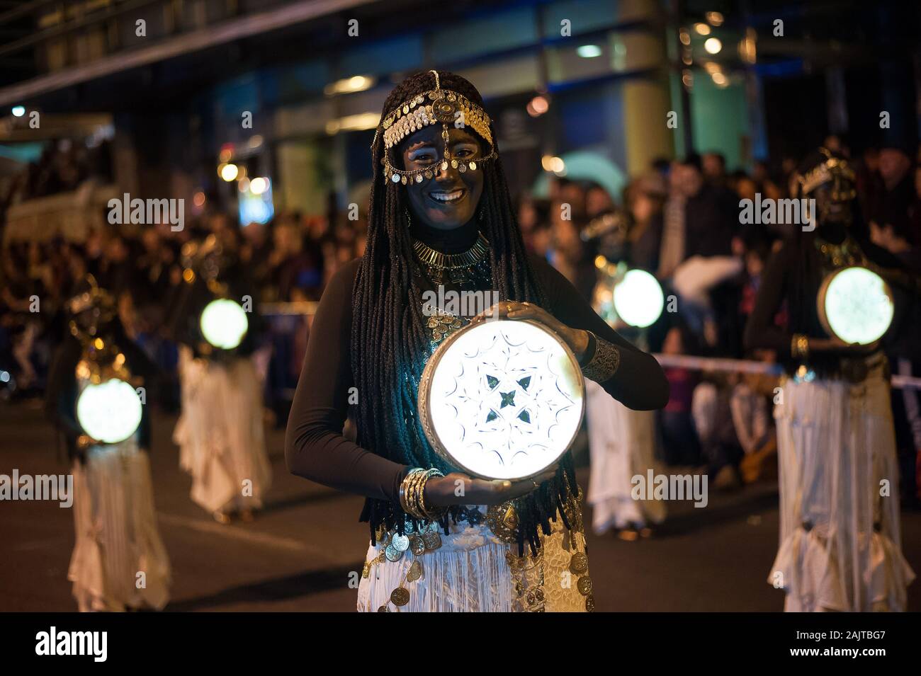 Women dressed in fantasy costumes perform on the street during the ...