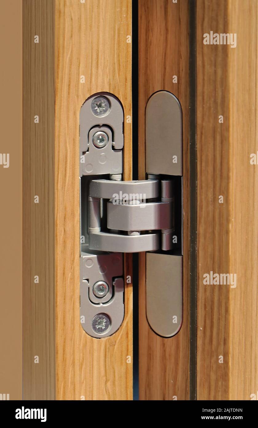 Metal hinge detail on open wooden door Stock Photo - Alamy