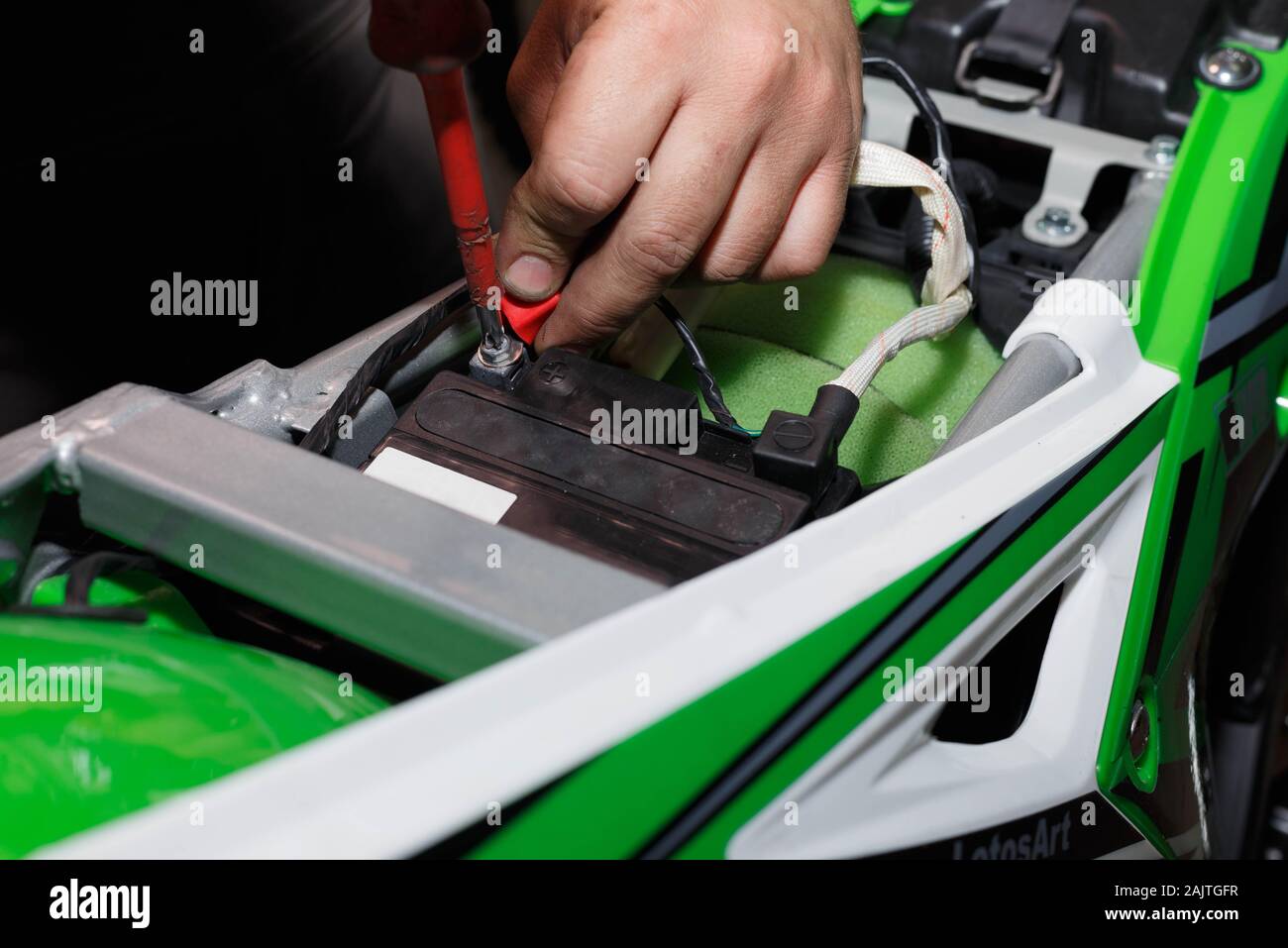 The wizard installs a new battery on the motorcycle after refueling and ...