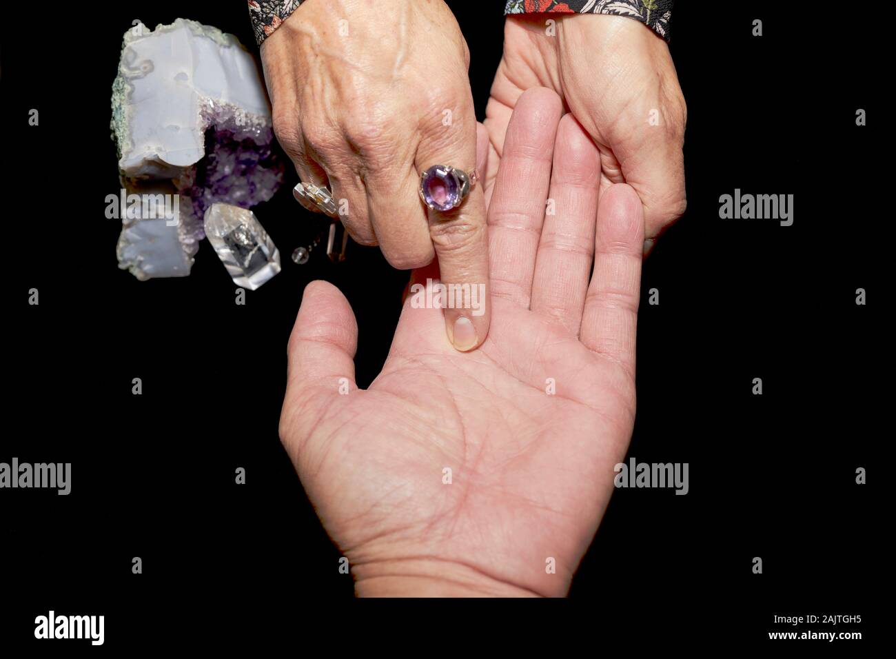 Palm Reader pointing to a line on someone's palm to read it Stock Photo ...