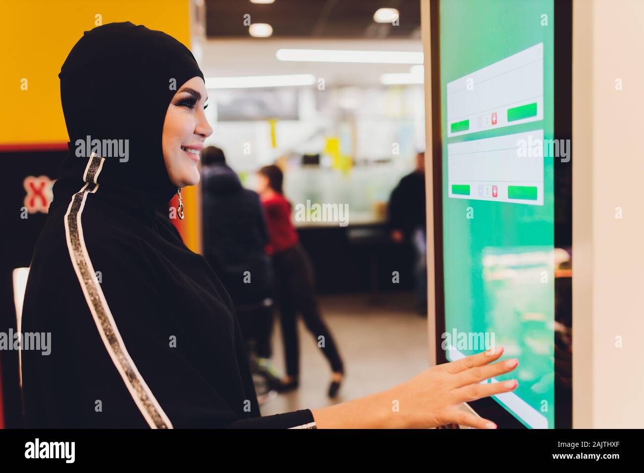 Arab girls at fast food restaurant eating burger payment terminal Stock ...