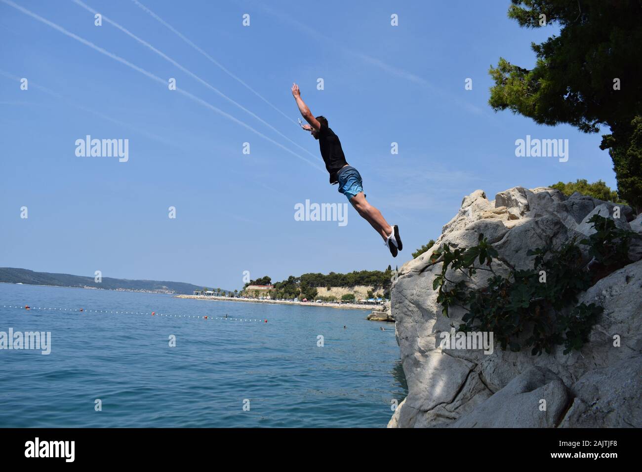 Dynamic Jump into the sea in Croatia Stock Photo - Alamy