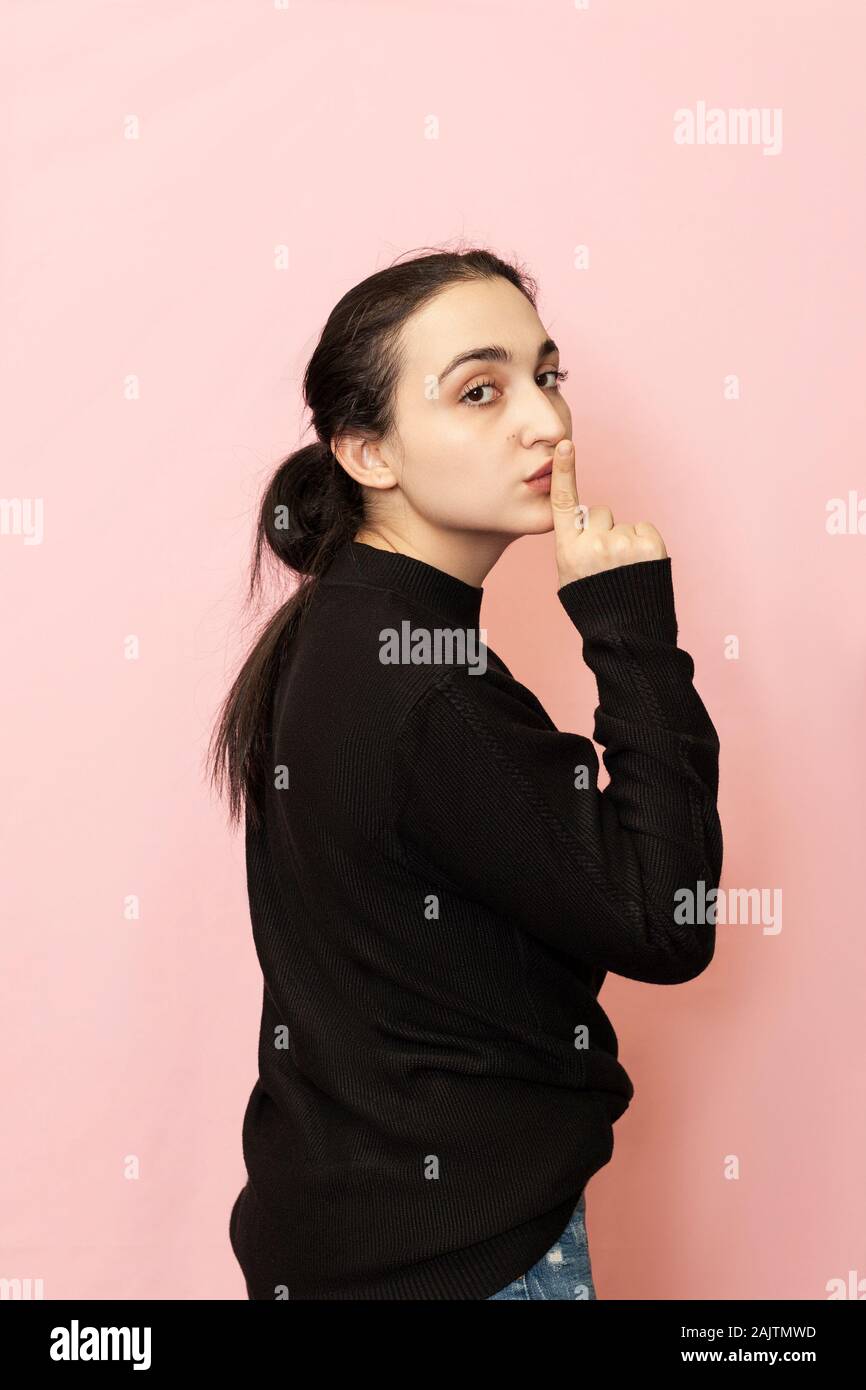 Keep quiet sign. Portrait of a beautiful woman in casual clothing ...