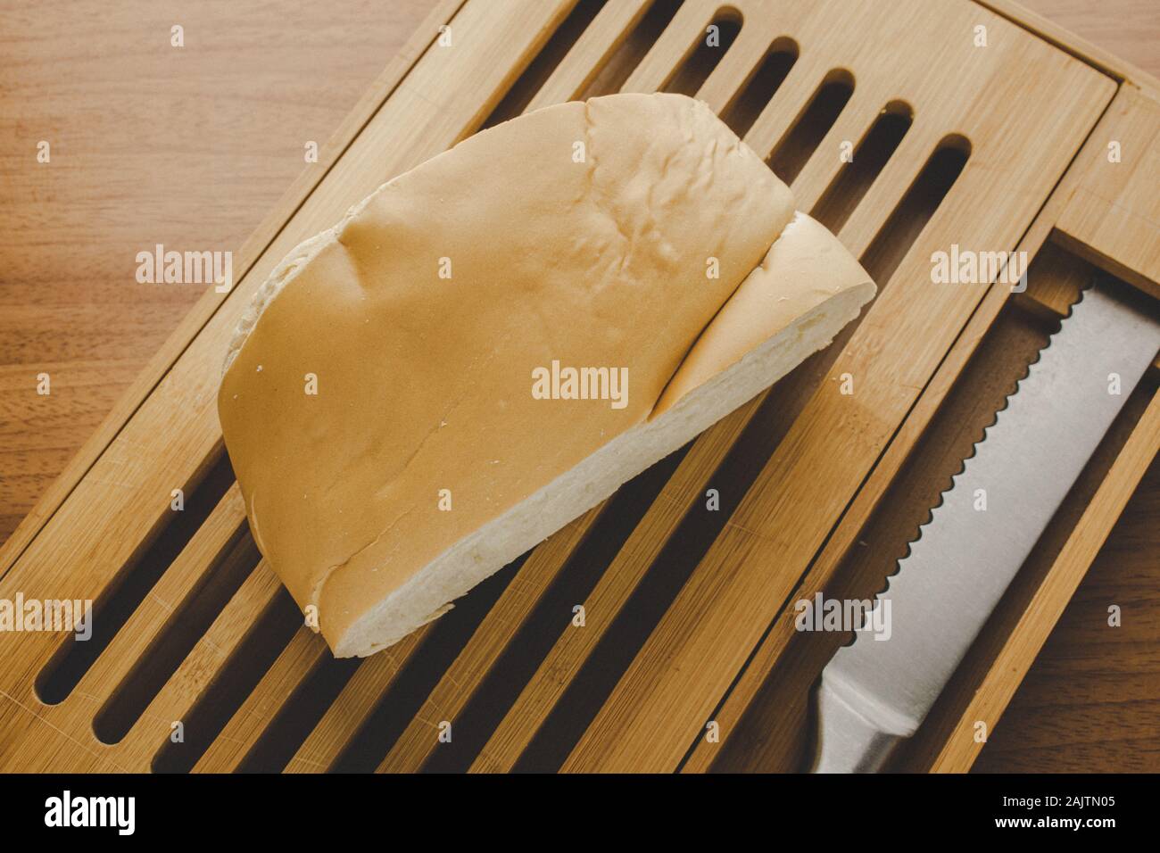 Cutted bread at the table with knife Stock Photo - Alamy