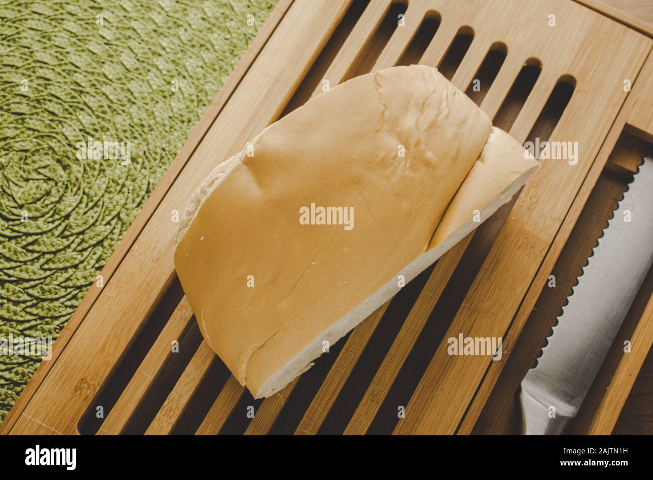 Cutted bread at the table with knife Stock Photo - Alamy