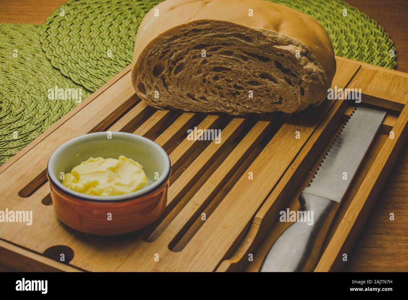Cutted bread at the table with knife and butter Stock Photo - Alamy