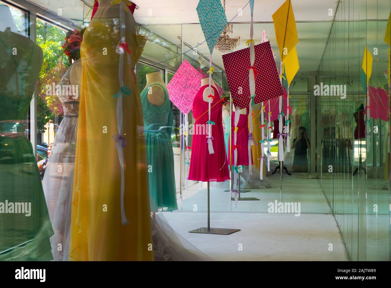 Colorful dresses in a shopfront window Stock Photo - Alamy
