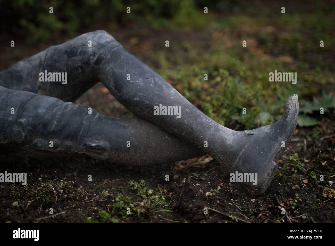 Stone legs crossed in a garden, old statue, spring dirt Stock Photo - Alamy