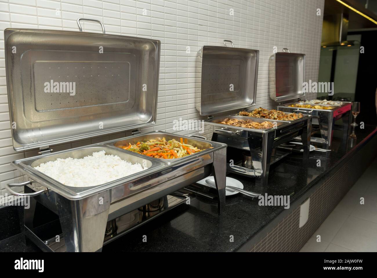 Black granite counter tops with food that will be served at the wedding ...