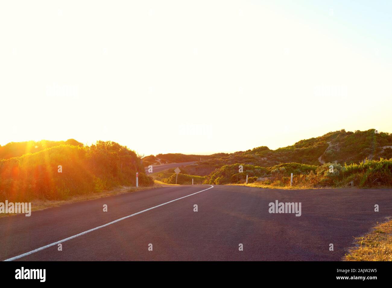 A photo of empty curly road on sunset in Australia. Australian typical ...