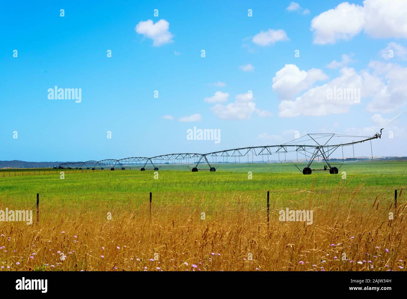 A photo of watering machine sprinkler on a farm Stock Photo - Alamy