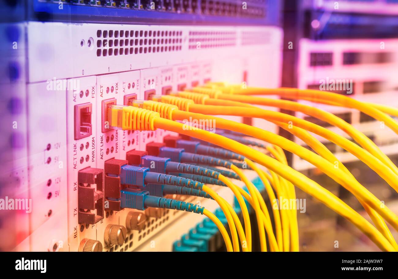 Fiber Optic cables connected to an optic ports and Network cables ...