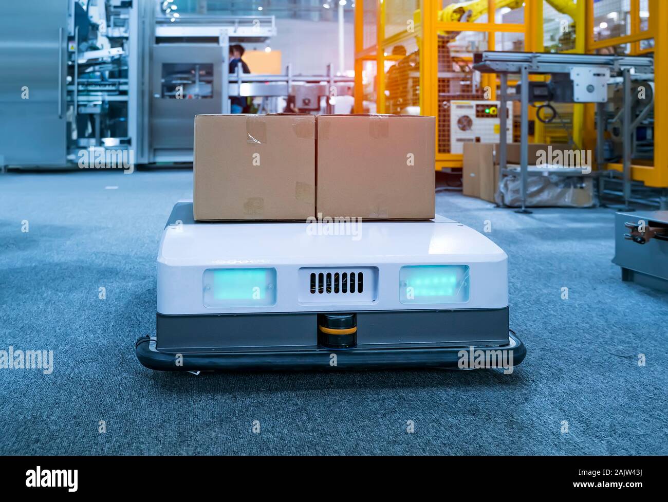 warehouse robot car carries cardboard box assembly in factory Stock ...