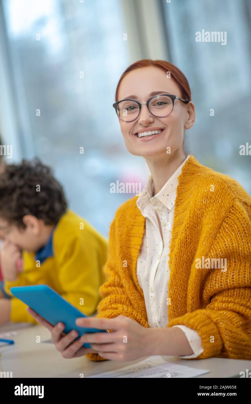 Happy teacher waiting while children having test Stock Photo - Alamy