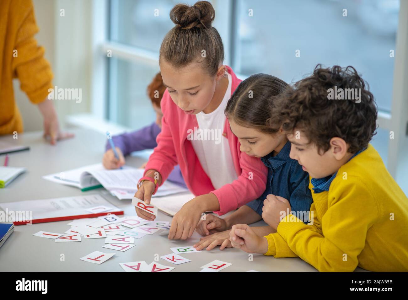 Children learning the alphabet while doing interesting tasks Stock ...