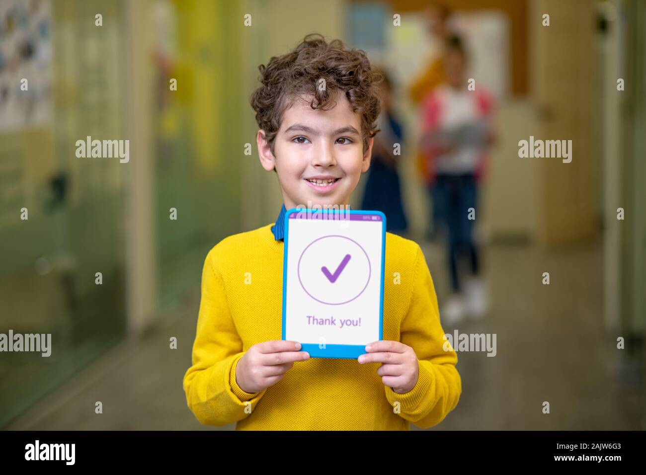 Little school boy smiling after completing his test Stock Photo - Alamy
