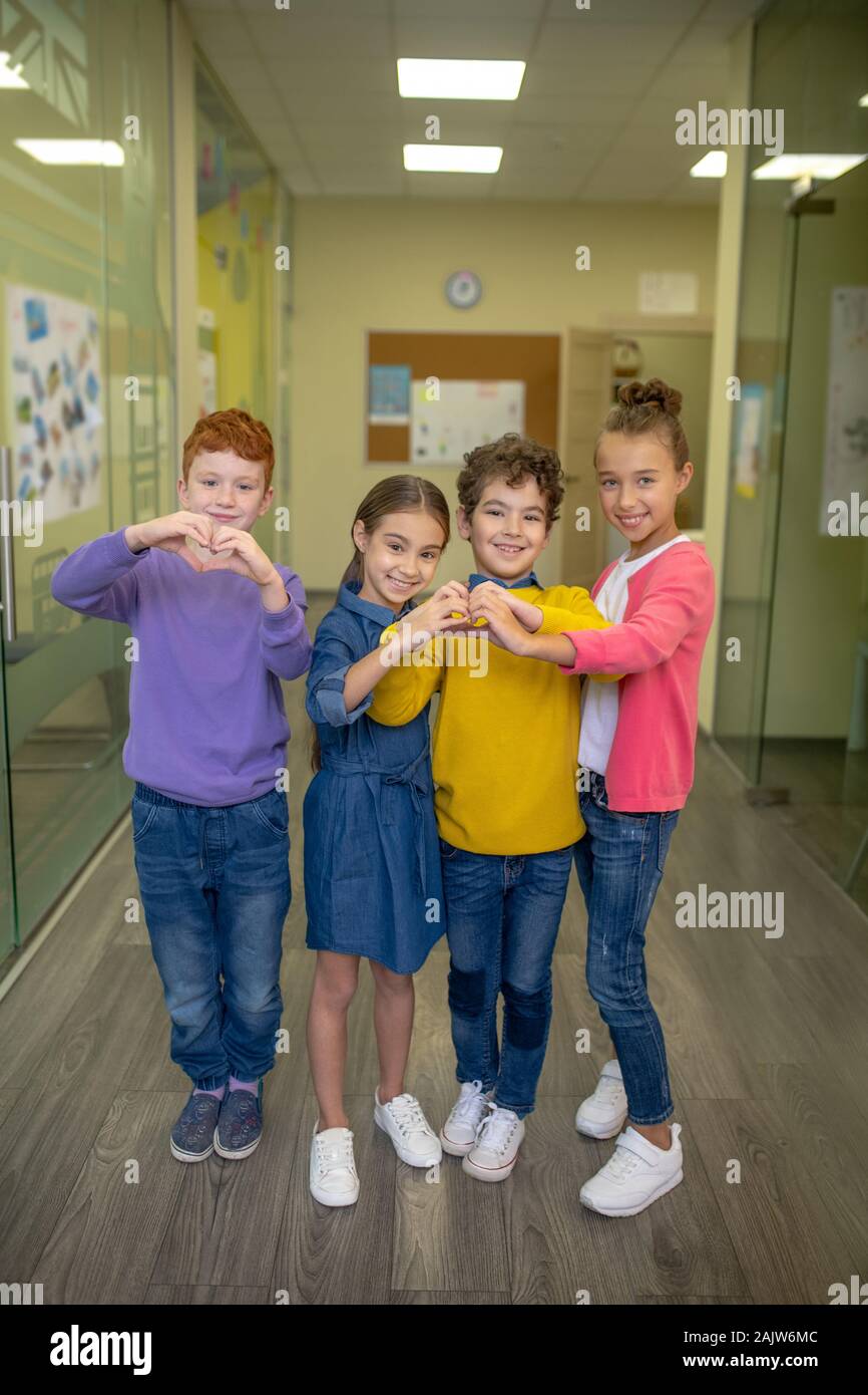 Friendly pupils showing their affection for each other Stock Photo - Alamy