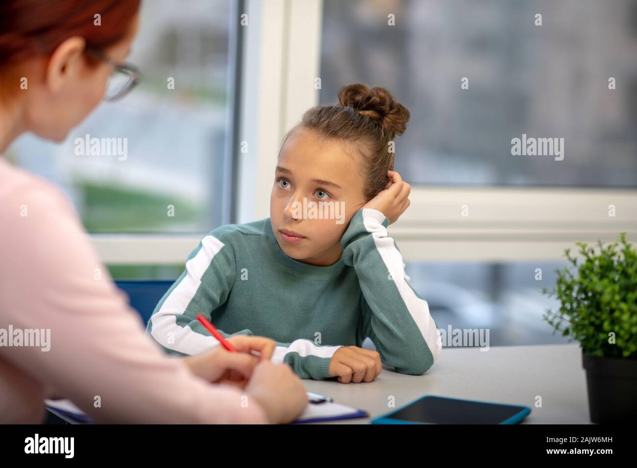Sad girl sitting in classroom hi-res stock photography and images - Alamy