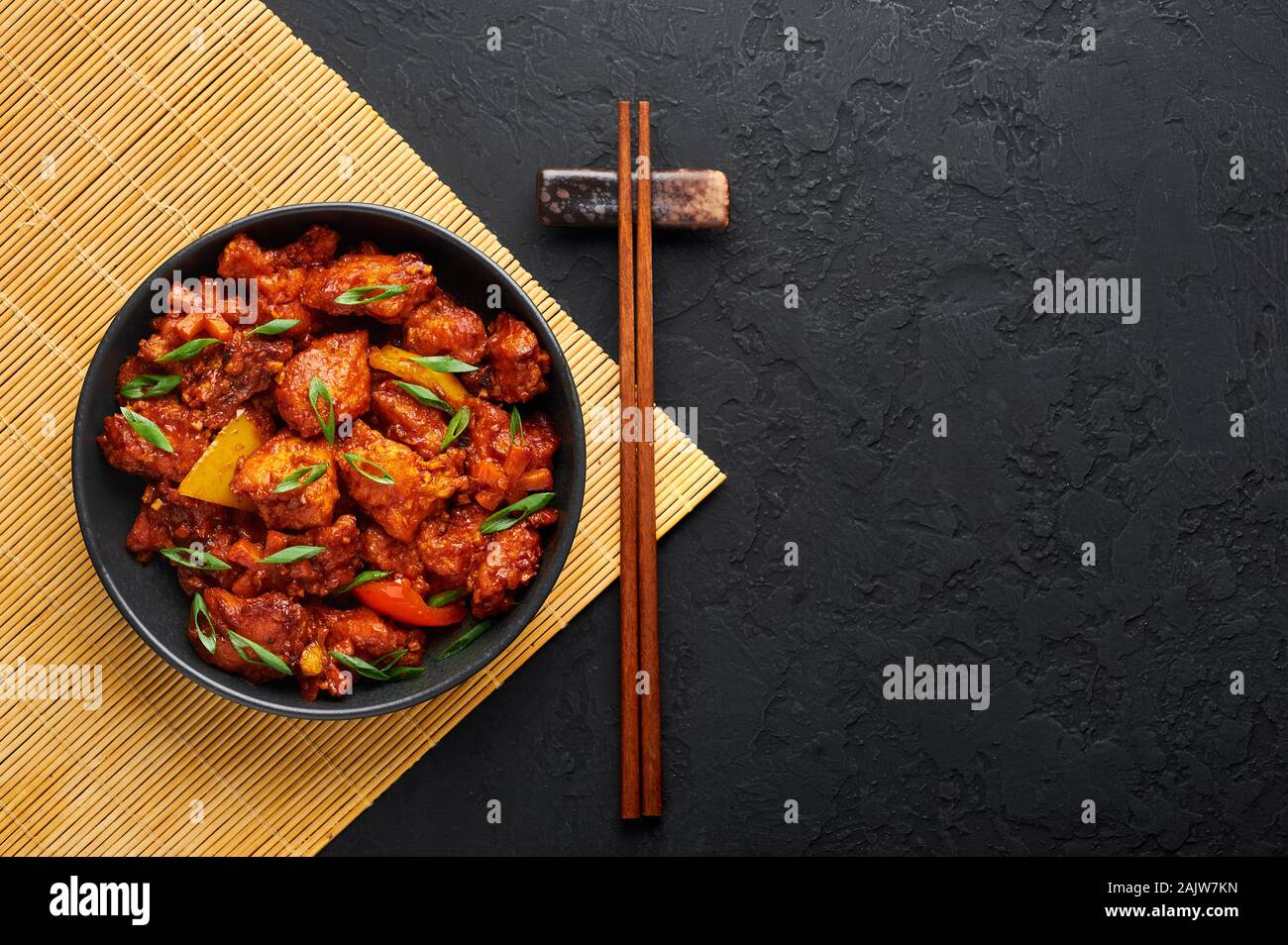 Fish Manchurian dry looks like Schezwan Fish in black bowl at dark ...