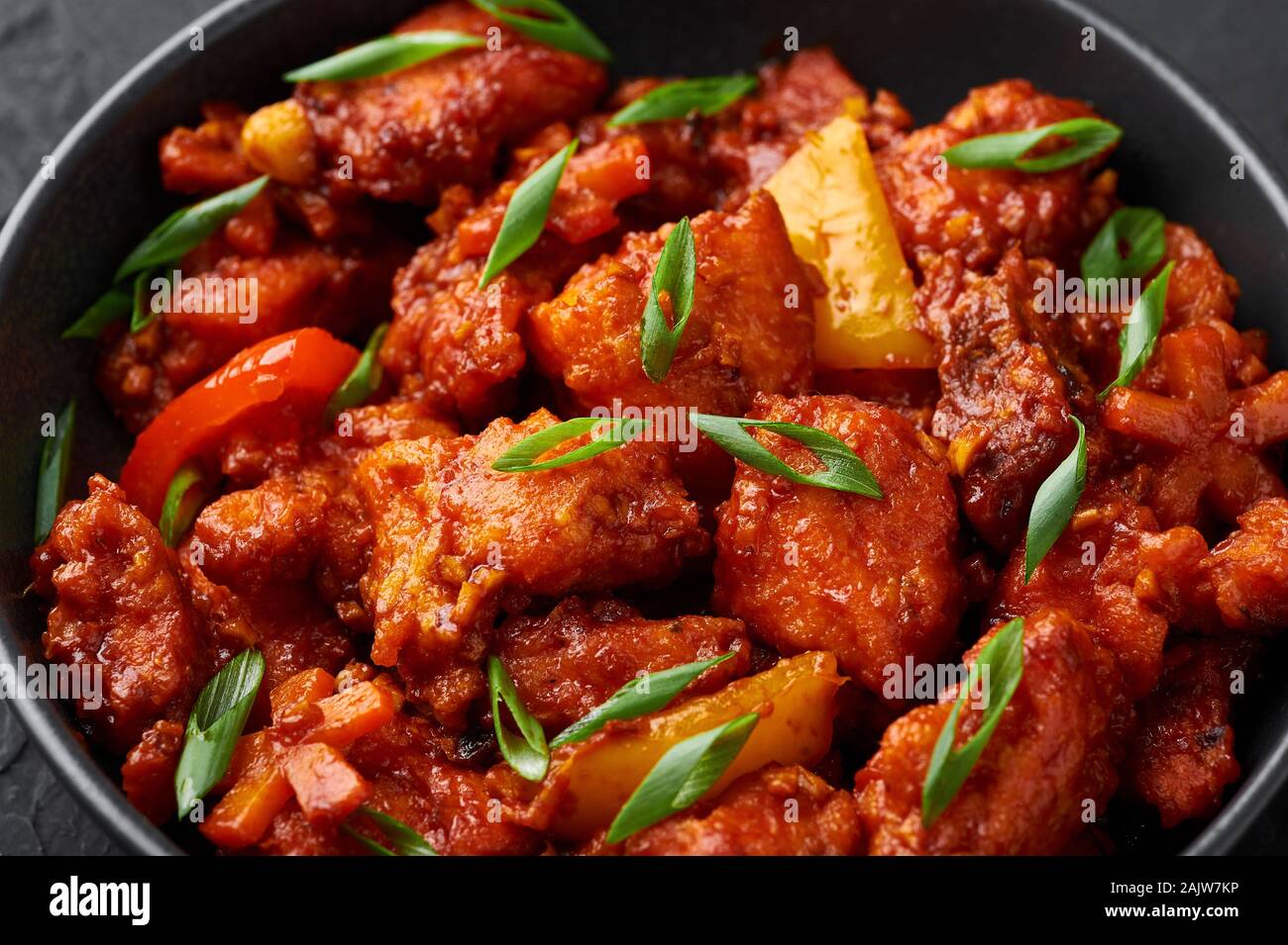 Fish Manchurian dry looks like Schezwan Fish in black bowl at dark ...