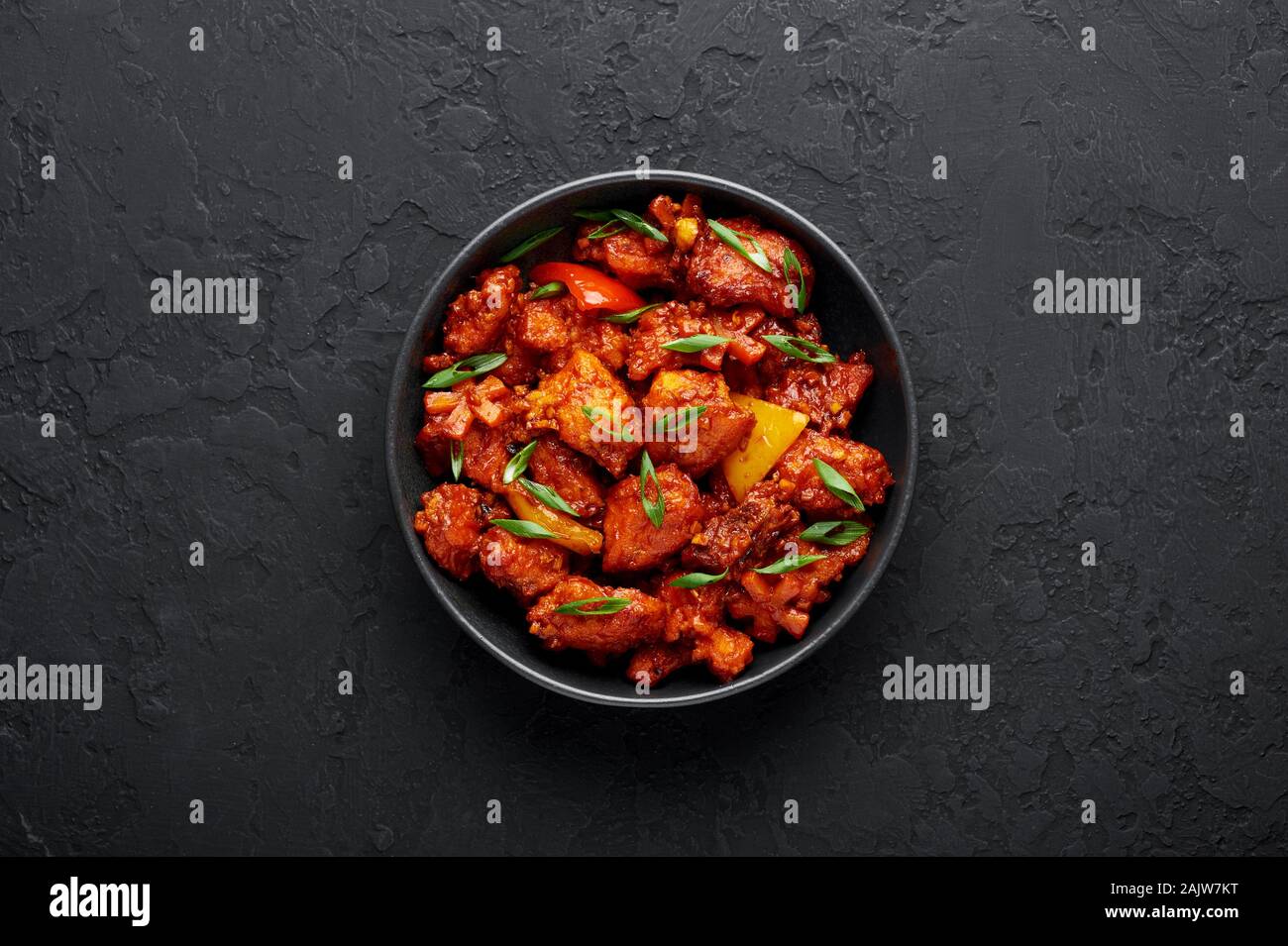 Fish Manchurian dry looks like Schezwan Fish in black bowl at dark ...
