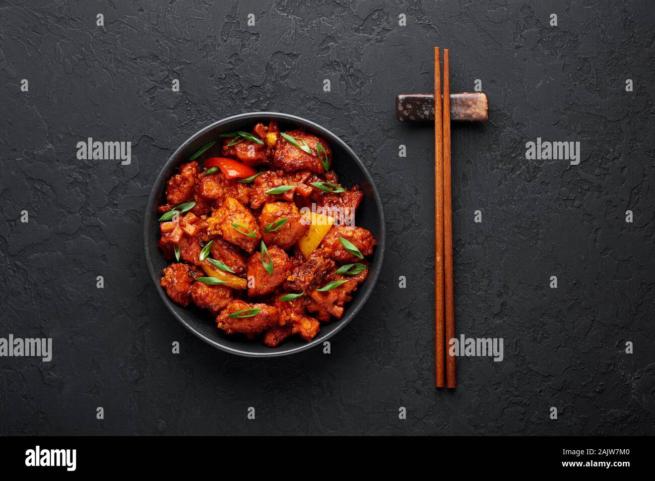 Fish Manchurian dry looks like Schezwan Fish in black bowl at dark ...